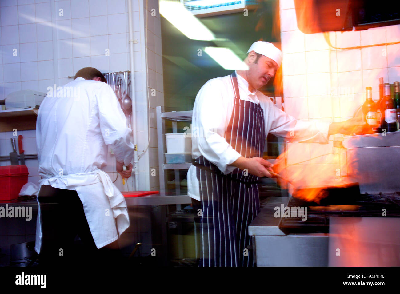 TWO PROFESSIONAL CHEFS WORKING IN COMMERCIAL KITCHEN Stock Photo - Alamy