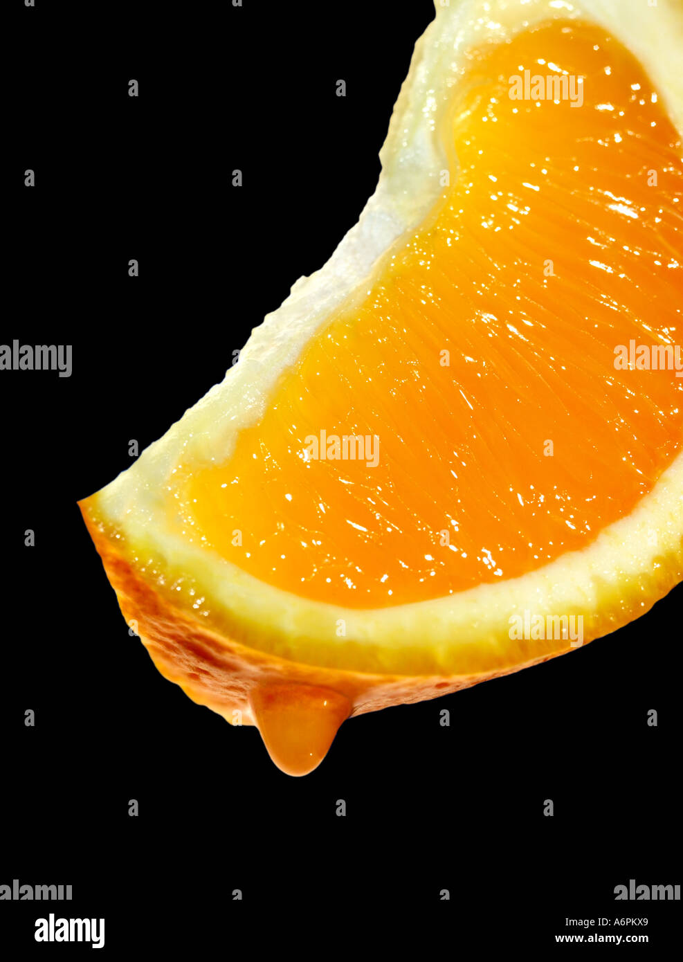 JUICY ORANGE SEGMENT WITH A DRIP CUT OUT ON BLACK BACKGROUND Stock ...