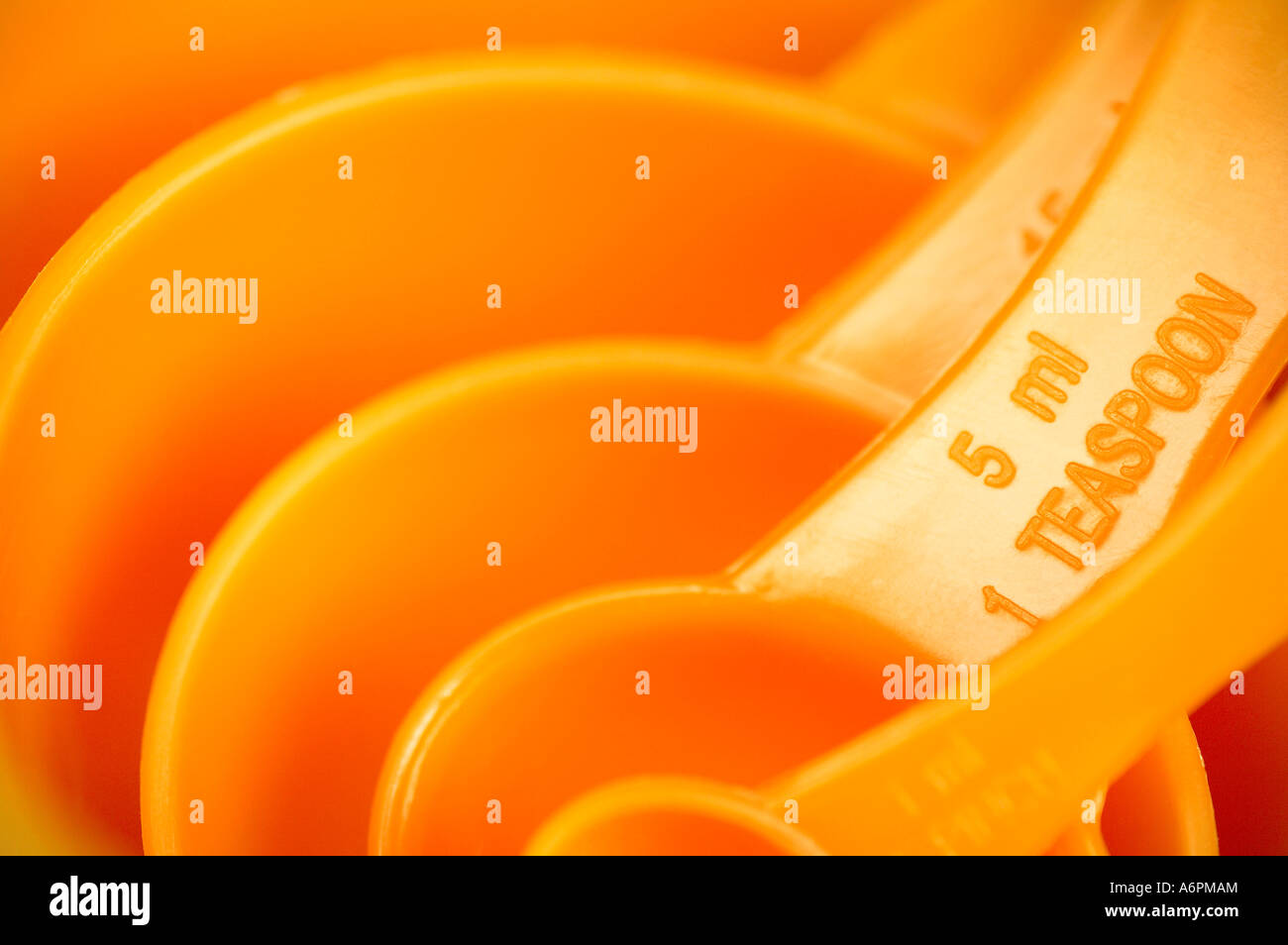 Orange measuring spoons macro Stock Photo - Alamy