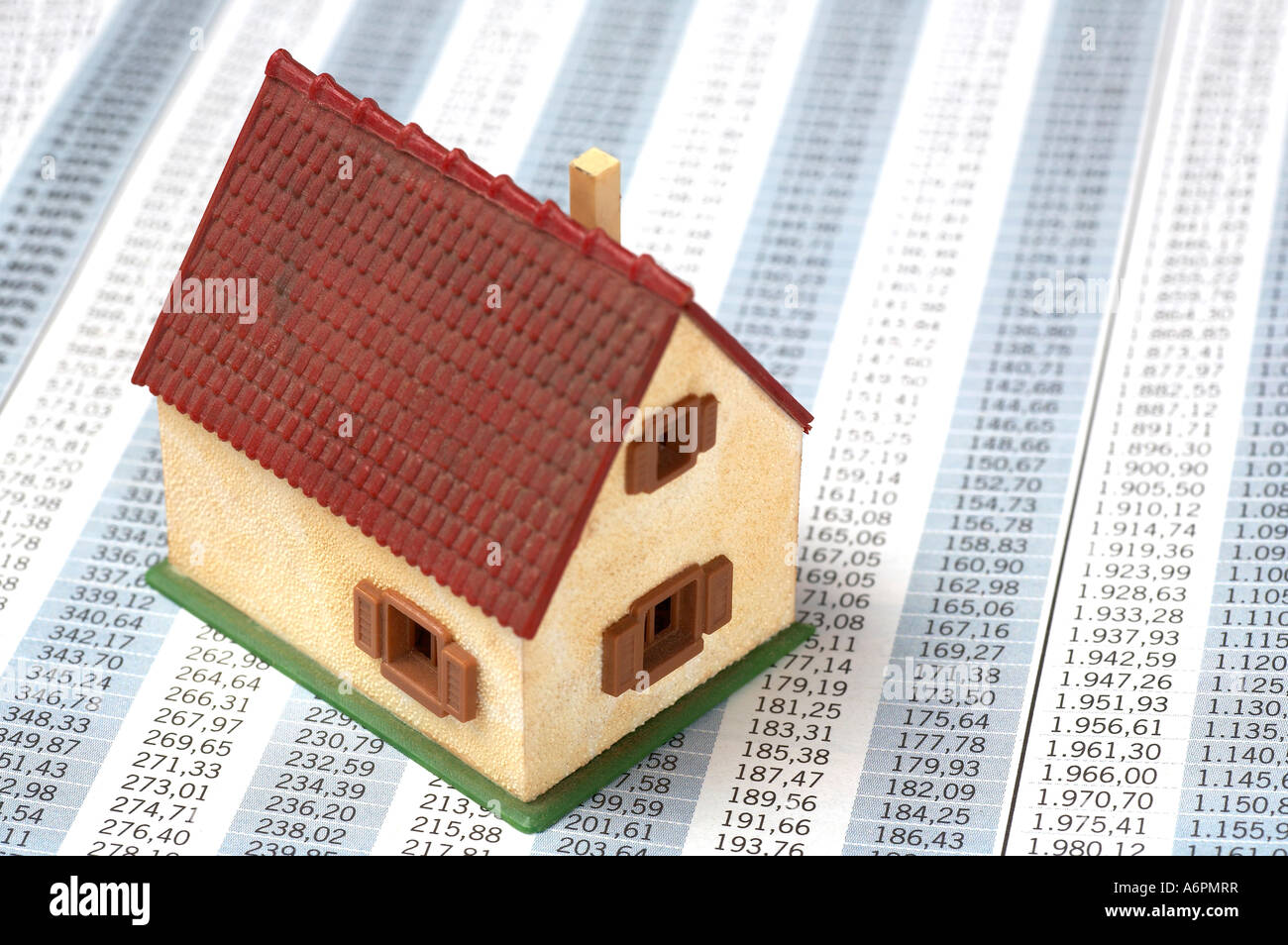 Miniature house on financial newspaper Stock Photo - Alamy