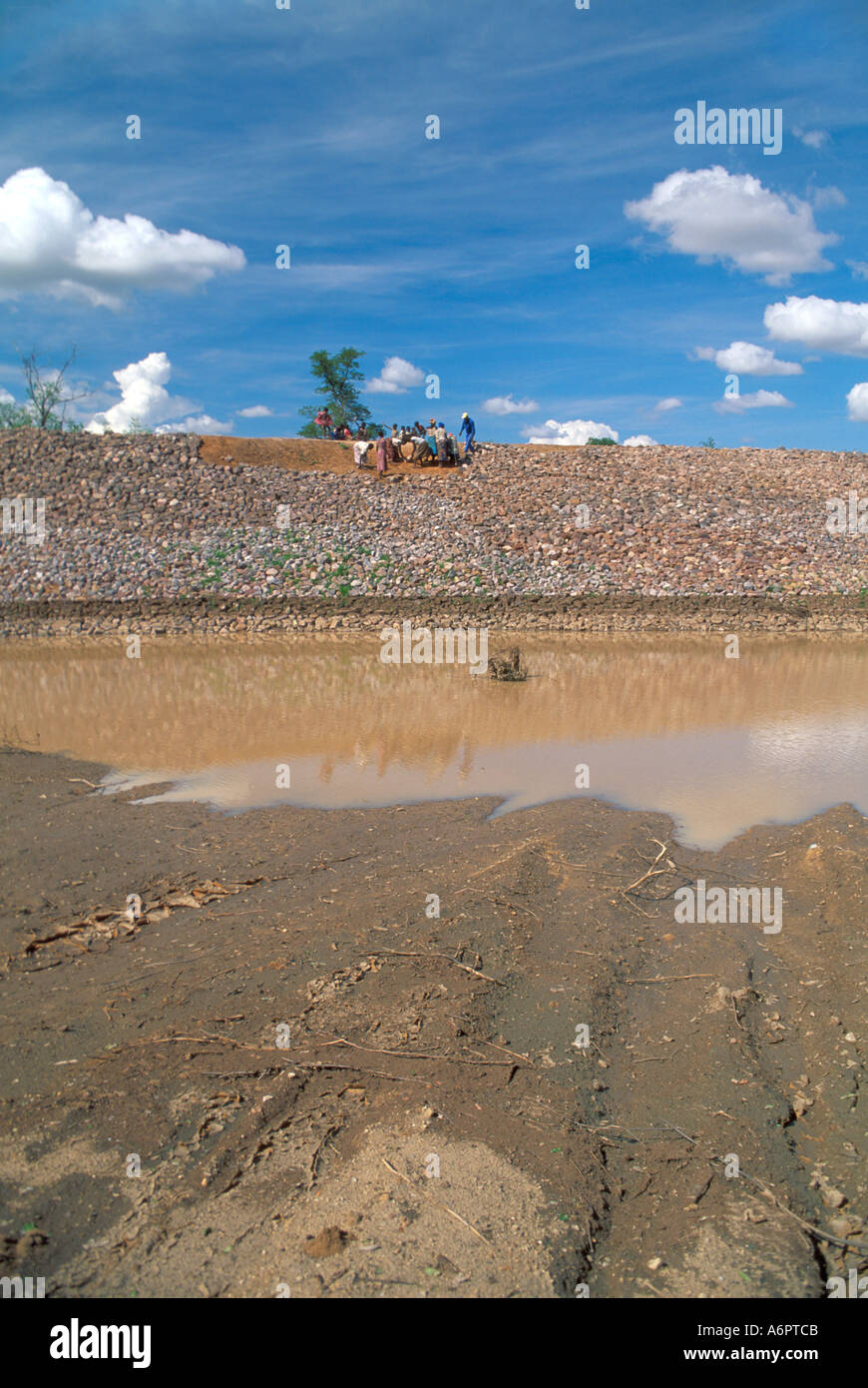 Long view of a community dam-building on a project to create a ...