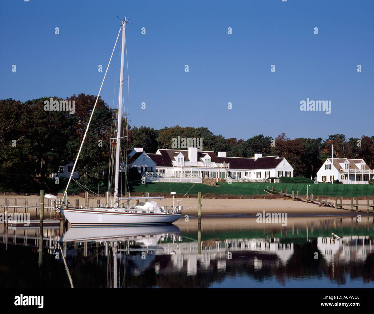 Yacht in front of Cape Cod mansion, reflected in water Stock Photo - Alamy