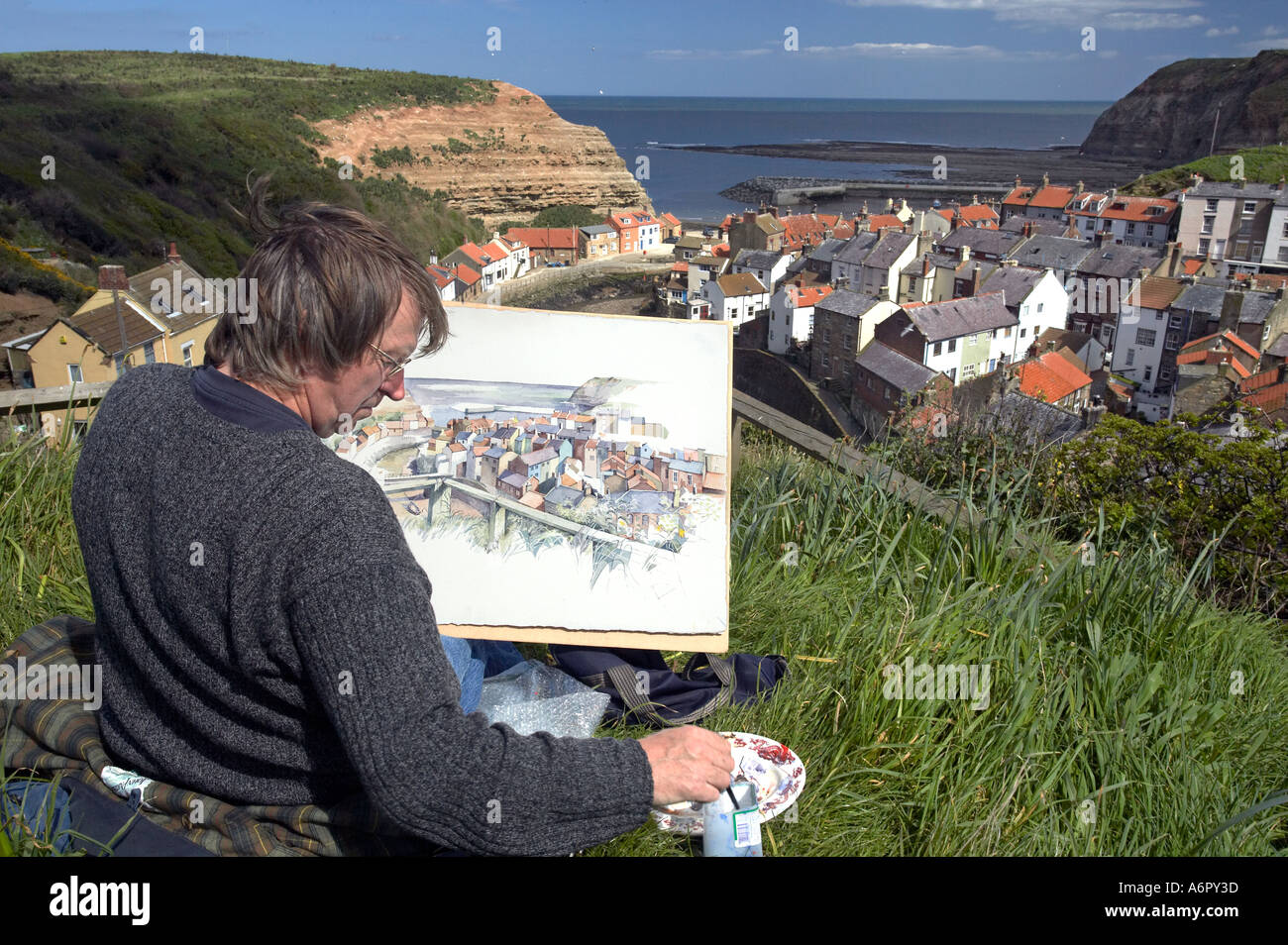 Artist Andy Hawkins of Saltburn painting Staithes Fishing Village North ...