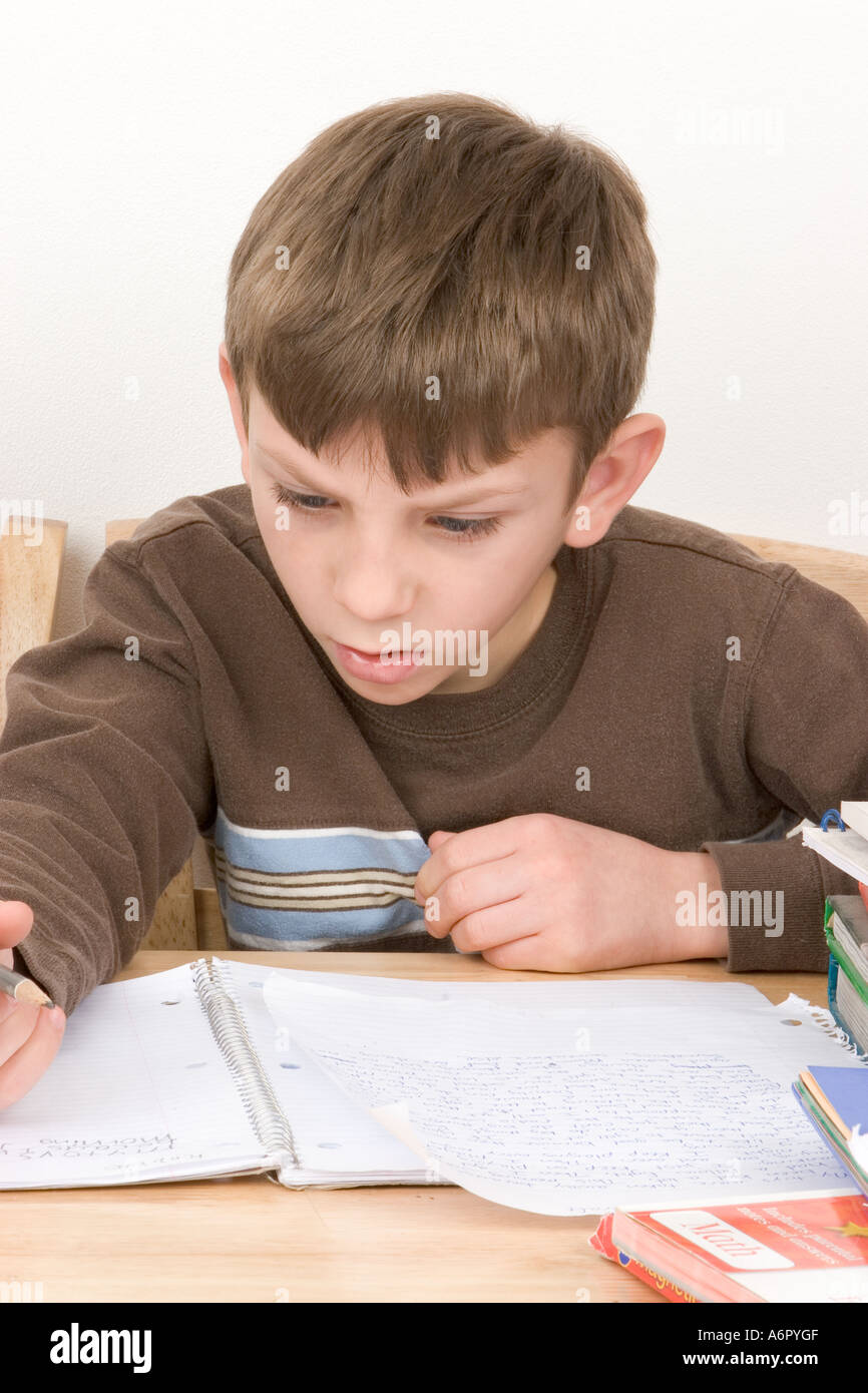 Boy doing home work sad expression on face hard work Stock Photo - Alamy