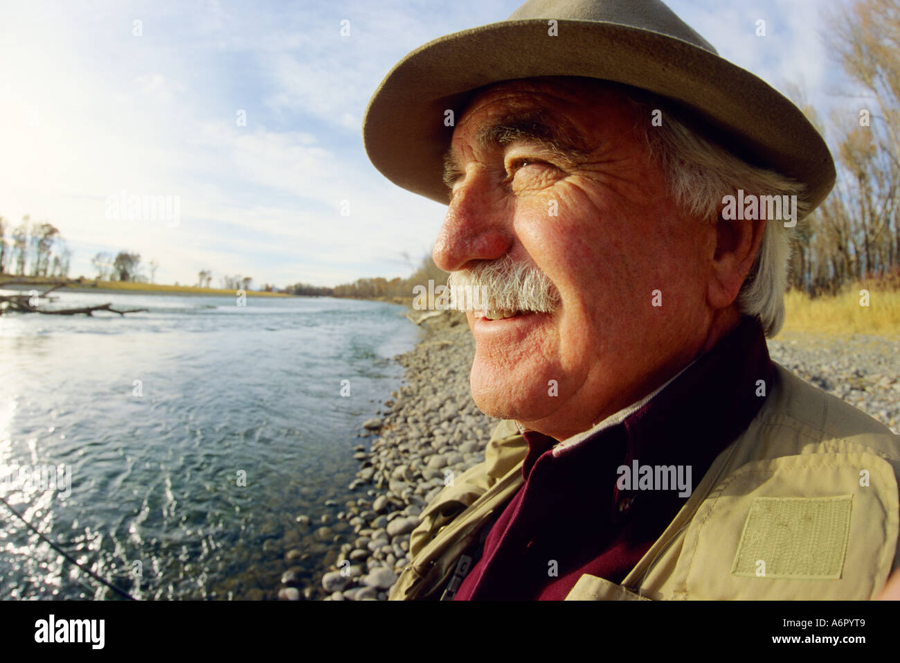 Close up of a fisherman looking at the river wide angle Stock Photo - Alamy