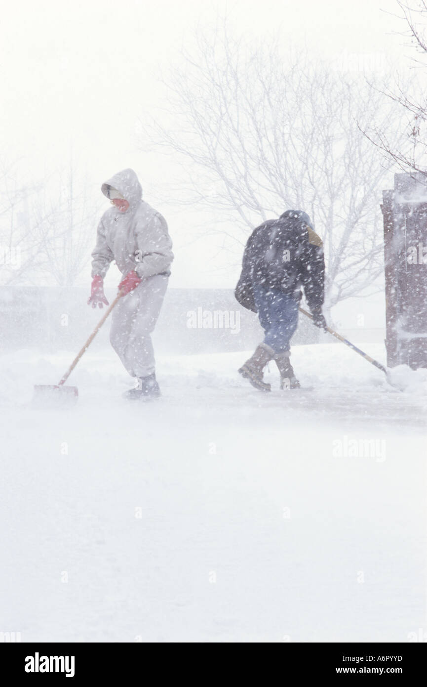 Shoveling snow in a storm Stock Photo - Alamy