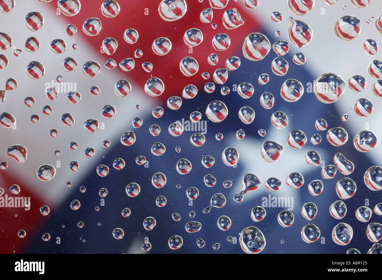 The flag of the United States of America is reflected in frozen rain ...