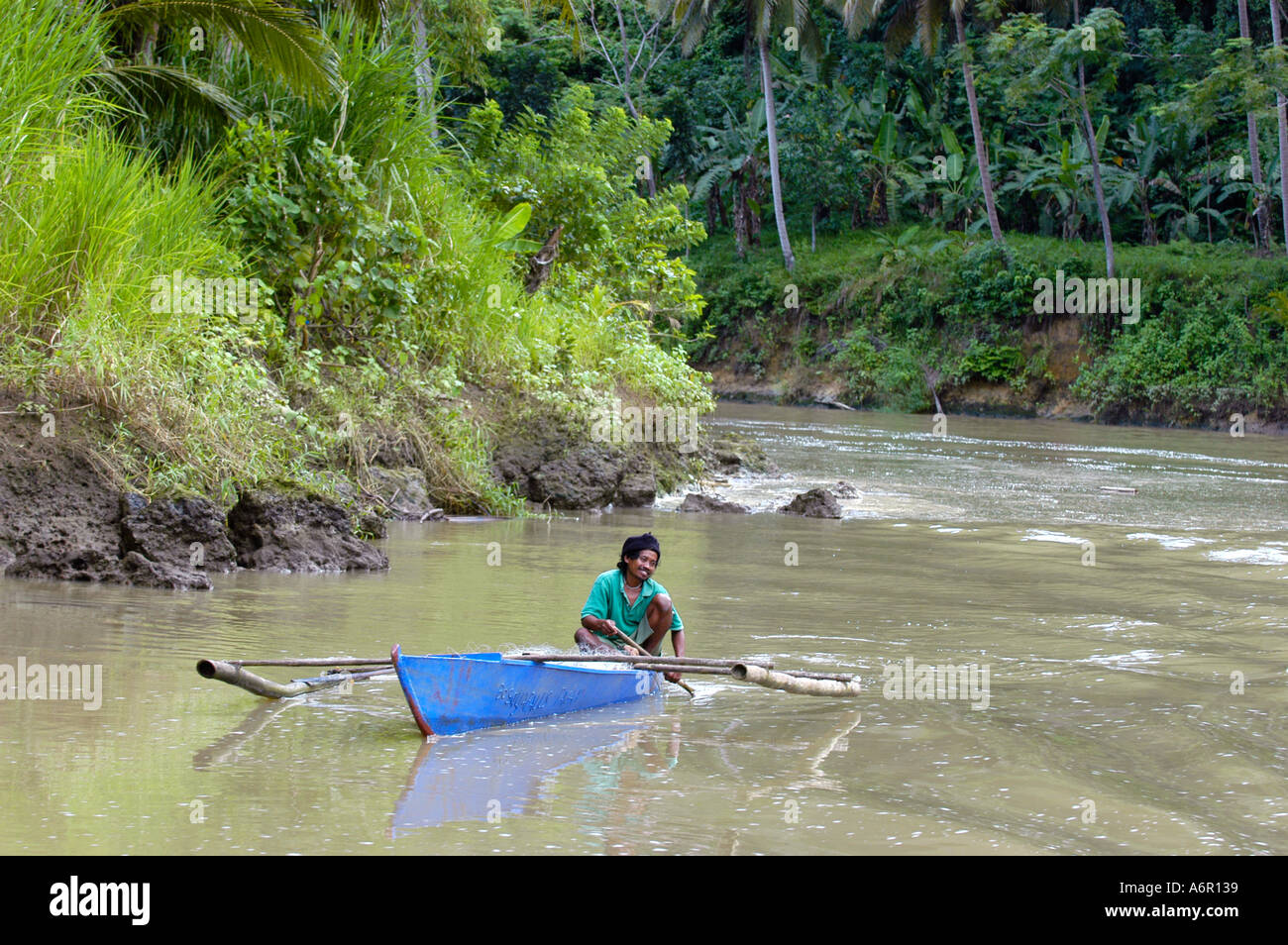 man Paddling down river in Bohol Philippines Stock Photo - Alamy