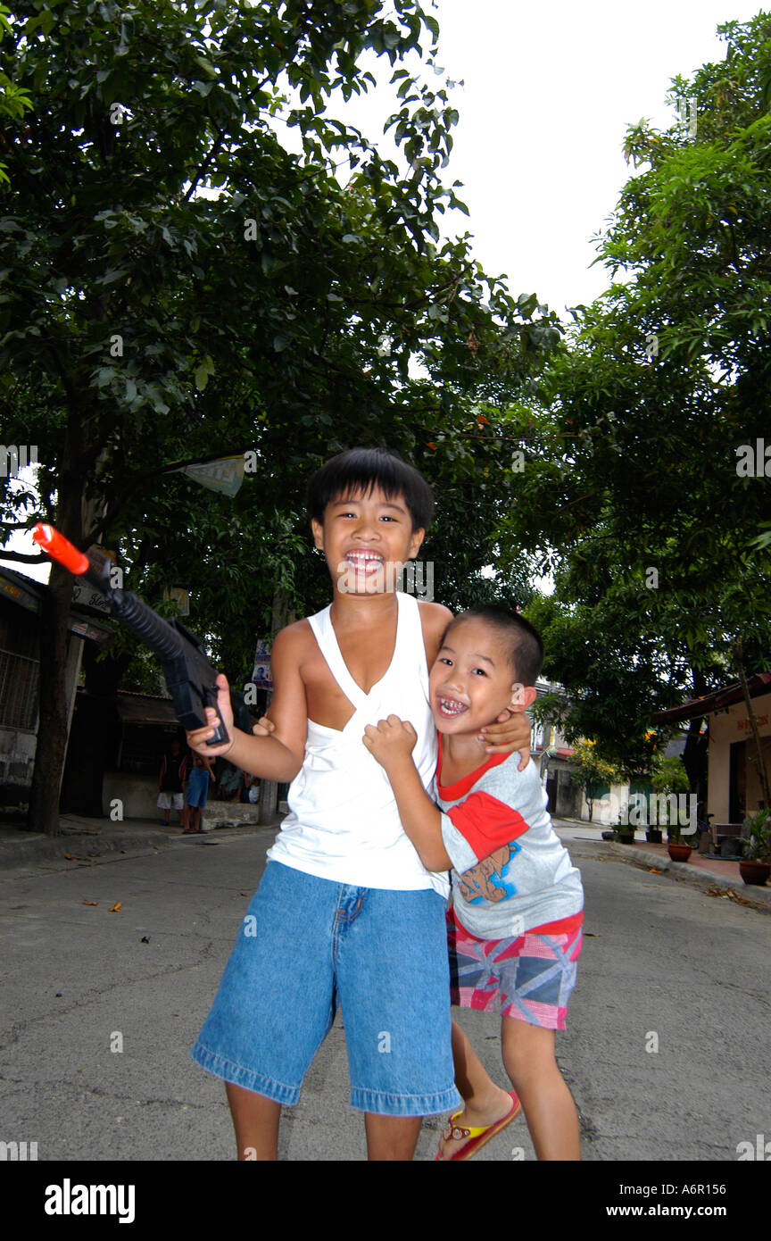 Kids playing with toy gun Stock Photo - Alamy