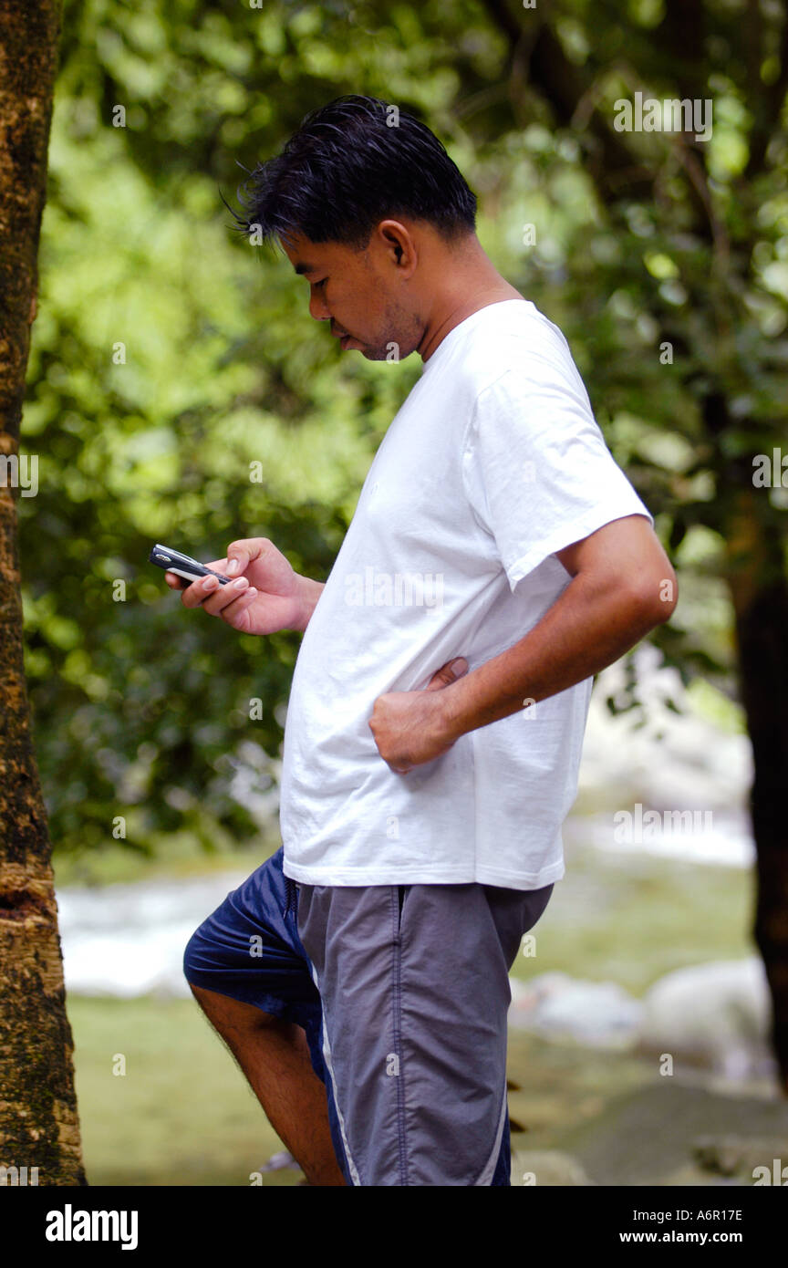 Sending a text from the jungle Stock Photo - Alamy