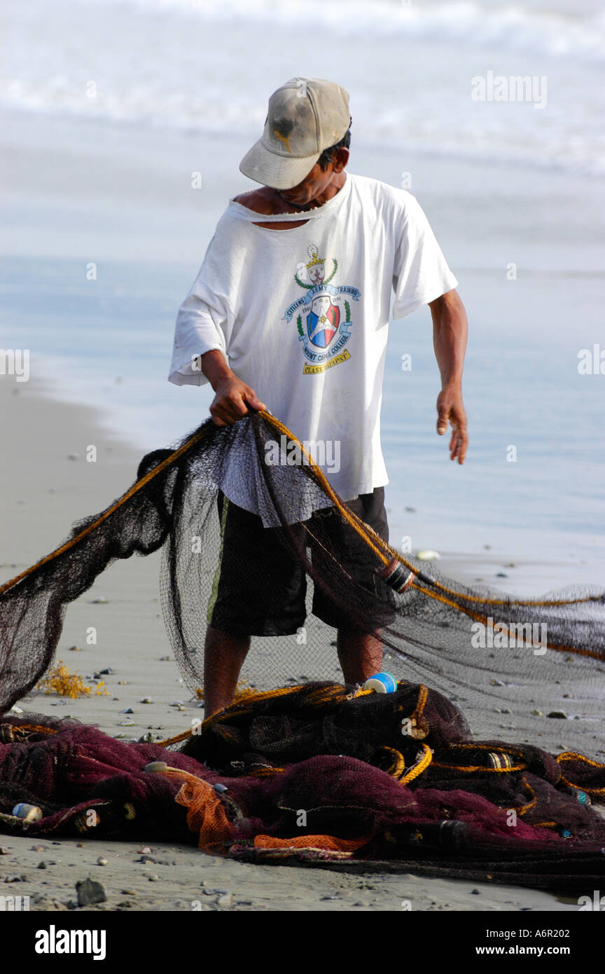 Man fishing on the beach Stock Photo - Alamy