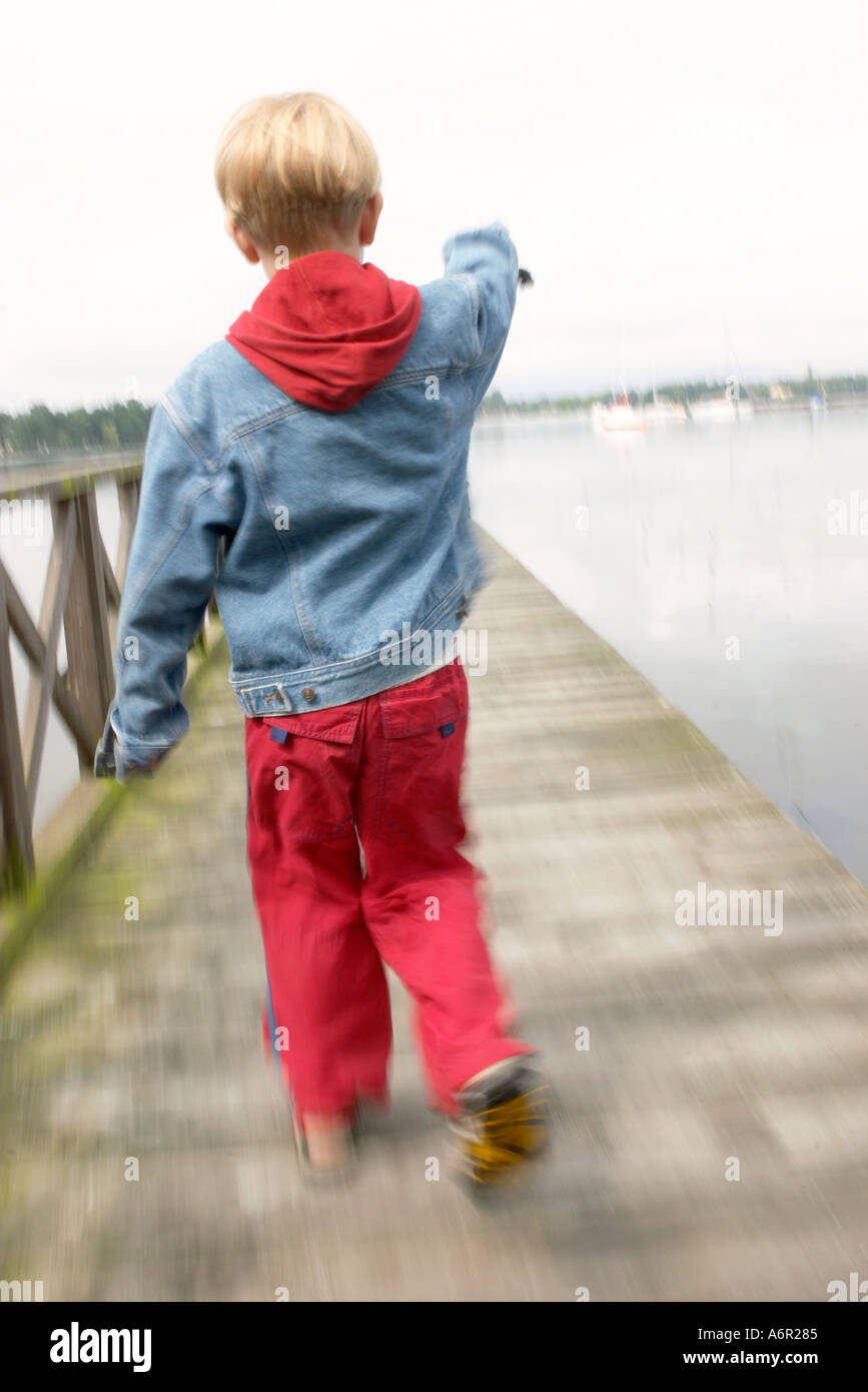 Boy on bridge in lake 6 years old Stock Photo - Alamy