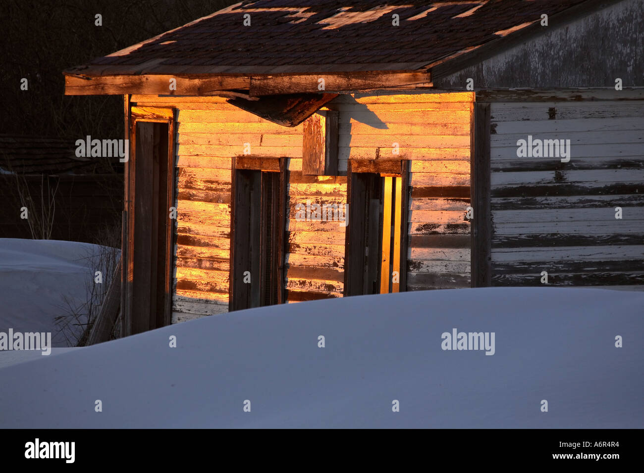 Snow drifts banked against an abandoned farm house in scenic ...