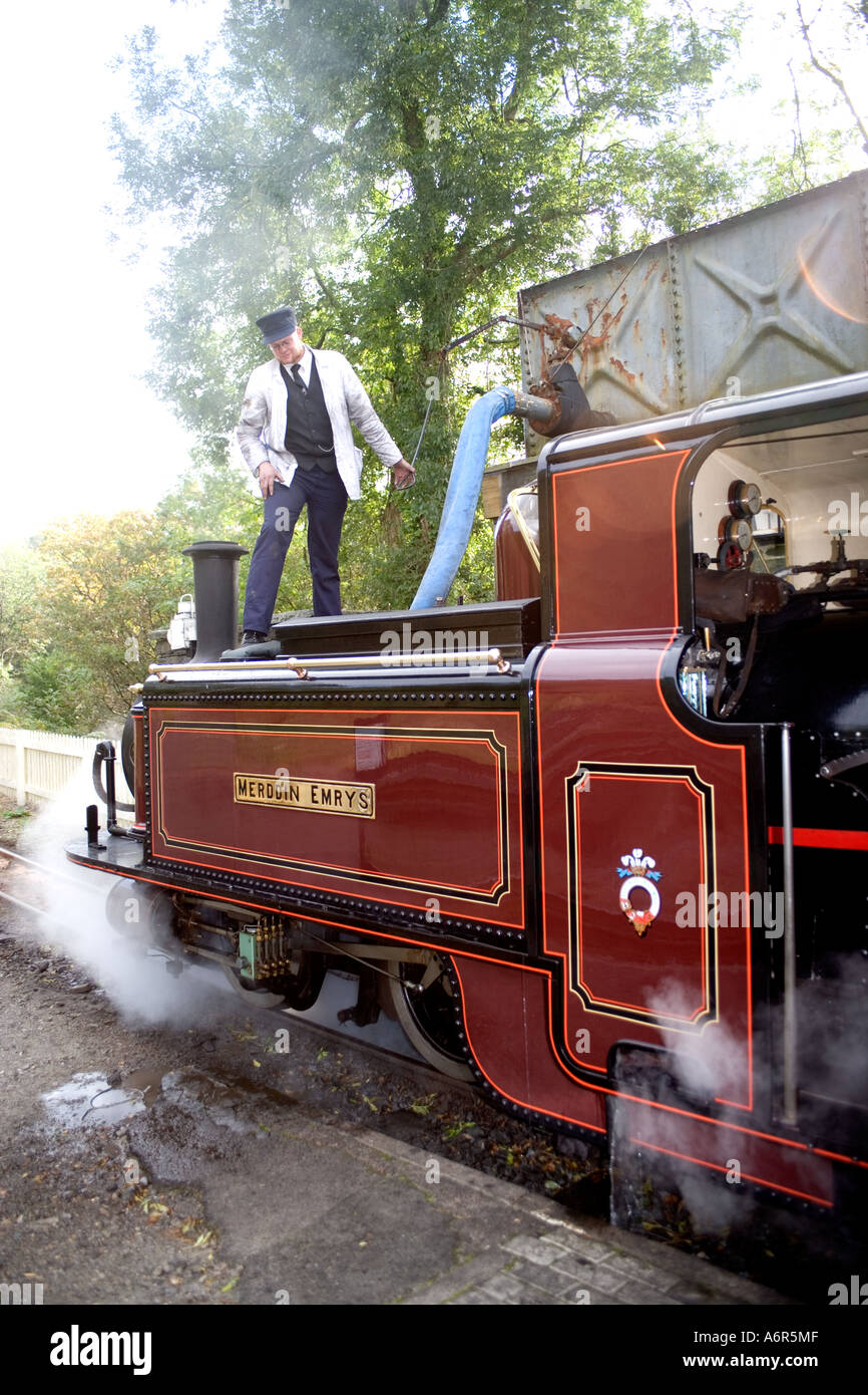 Steam train taking on water on the Ffestiniog railway at Tan y Bwlch ...