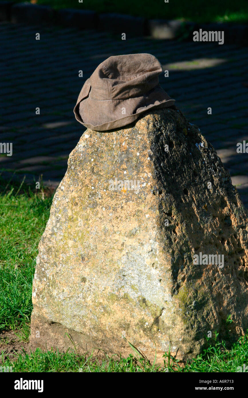 Discarded hat upon stone bollard by roadside Stock Photo - Alamy