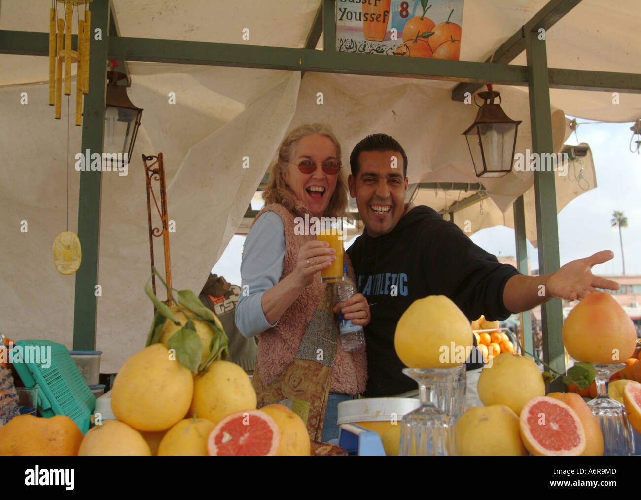 Orange juice seller with tourist Jemaa El Fna, Marrakech, Morocco ...