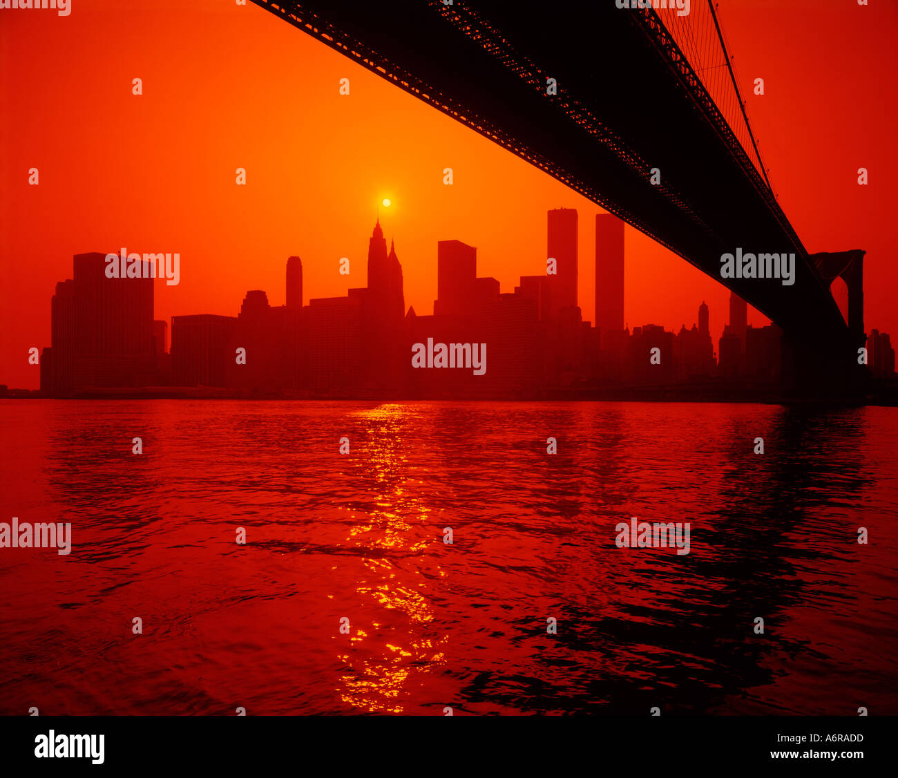 Lower Manhattan in New York seen at sunset from under the span of the ...