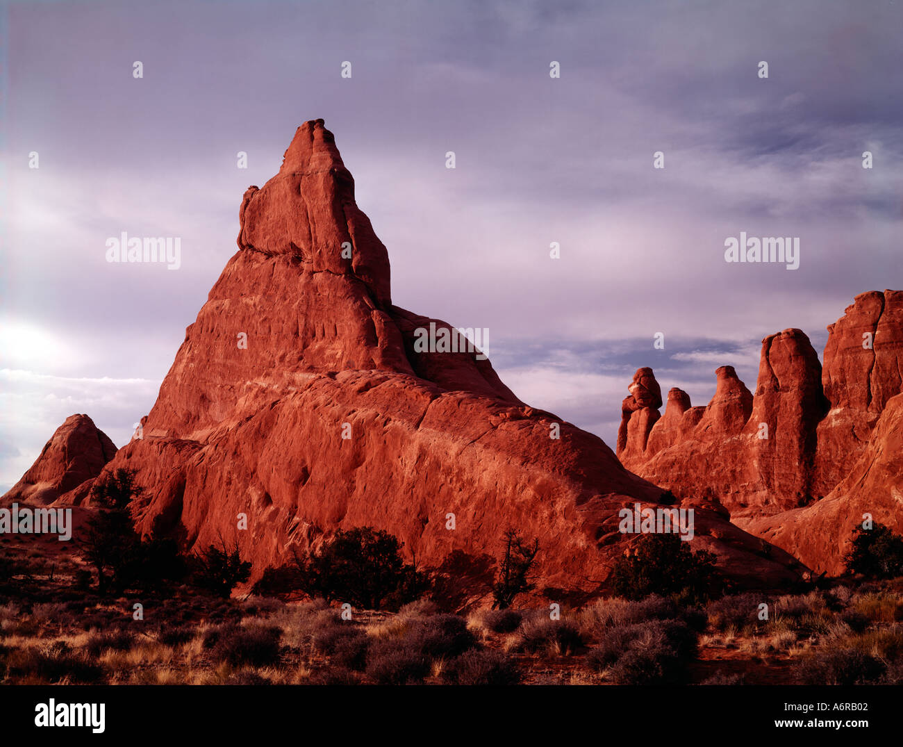 Arches National Park in Utah where a crimson colored rock monolith ...