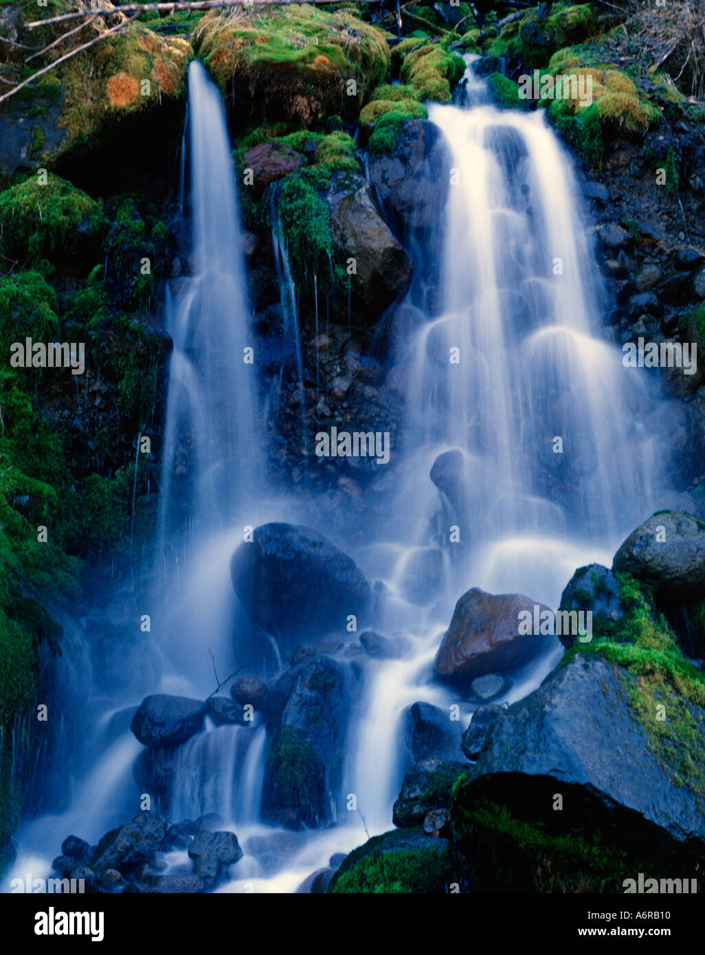 Waterfall cascading over rocky streambed on the slopes of Mount Hood in ...