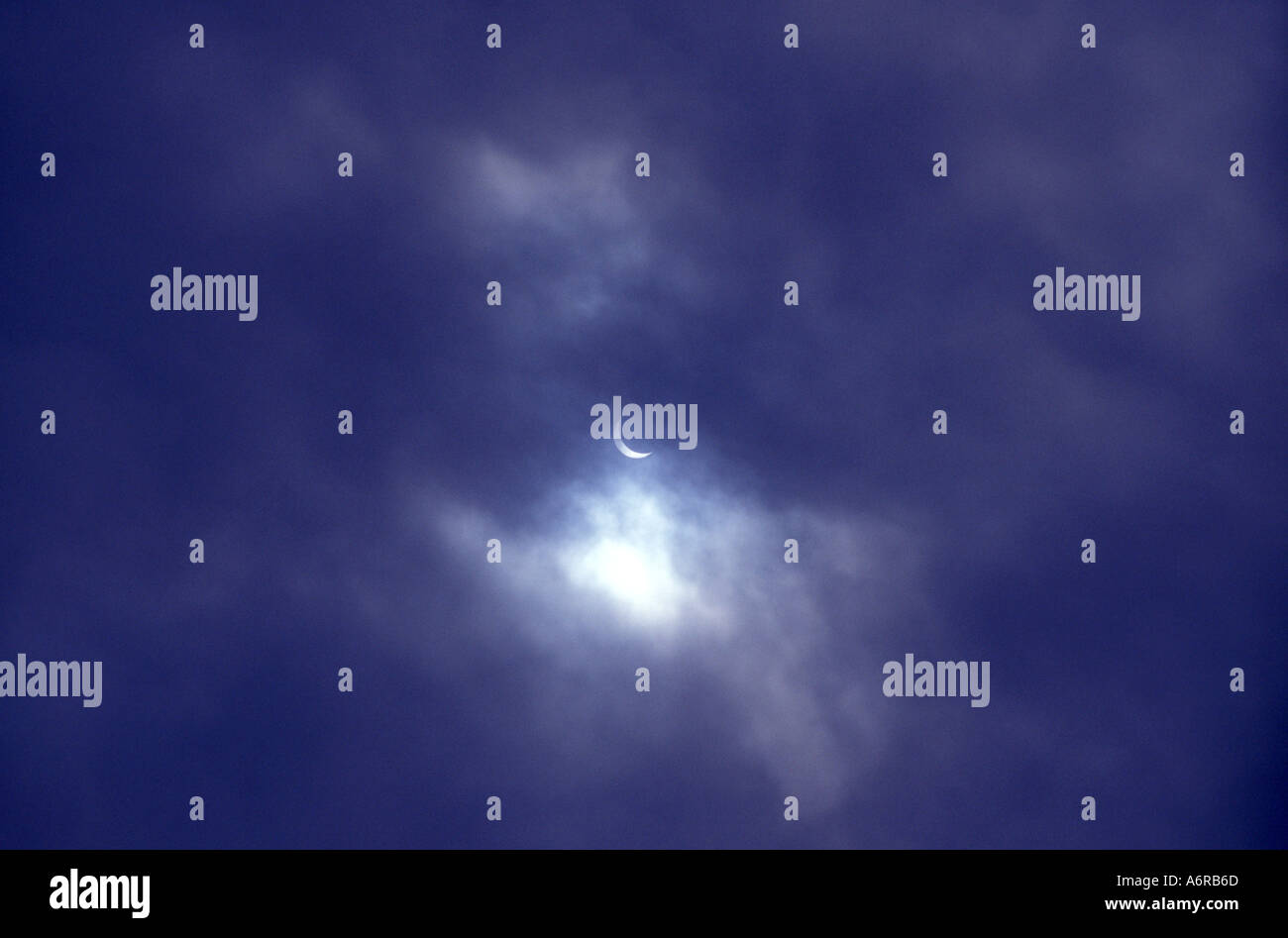 The Sun eclipsed by the moon in a dark brooding sky Stock Photo - Alamy