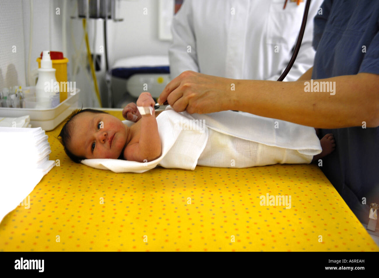 newborn baby first medical examination dark hair caucasian four days ...