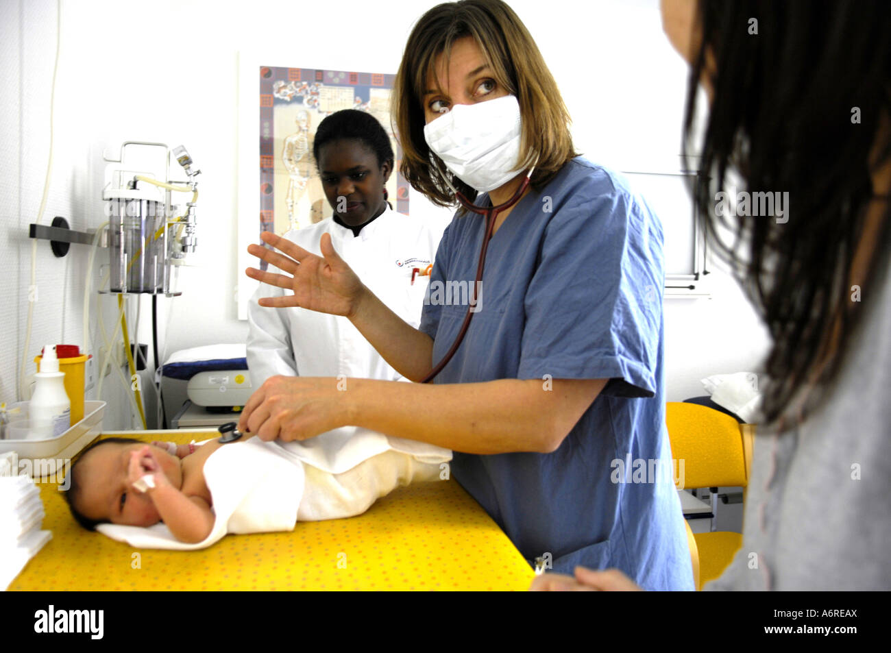 newborn baby first medical examination dark hair caucasian four days ...