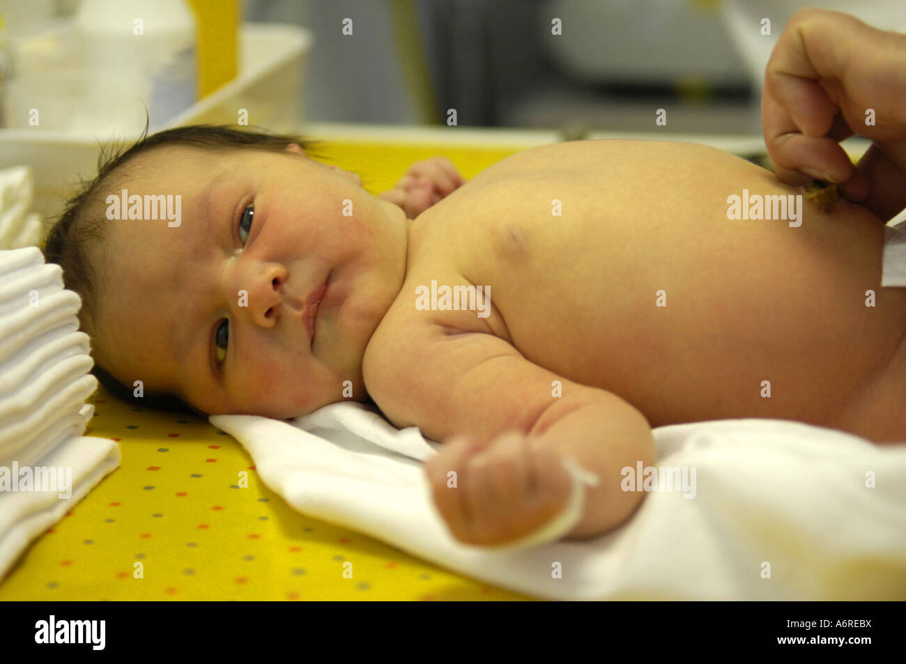 newborn baby first medical examination dark hair caucasian four days ...