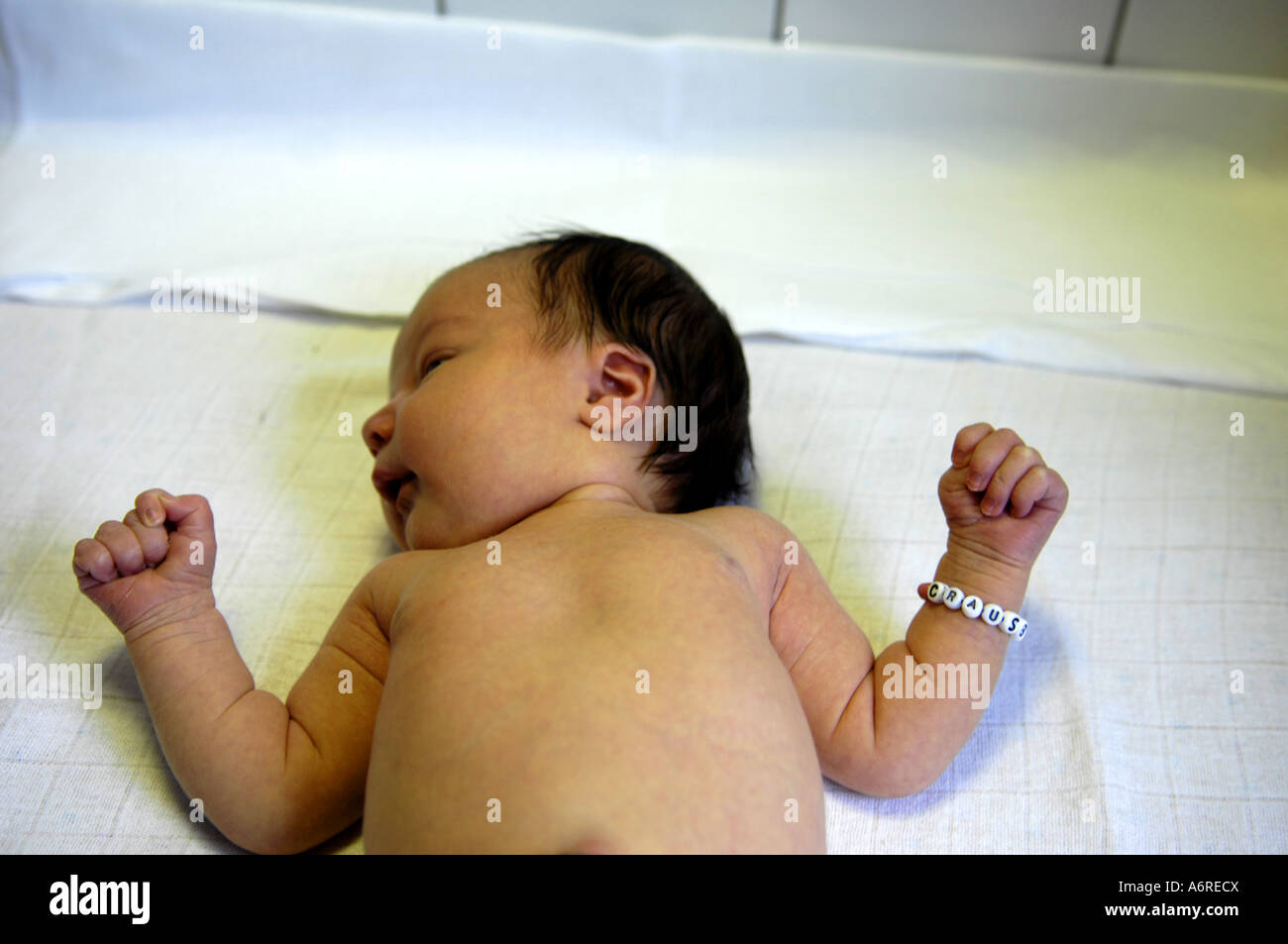 newborn baby name tag wristband identity dark hair caucasian four days ...