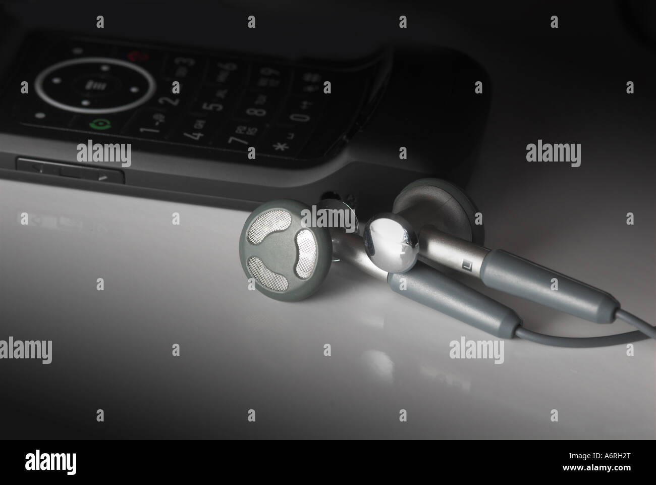 earphones attached to a cell phone Stock Photo - Alamy