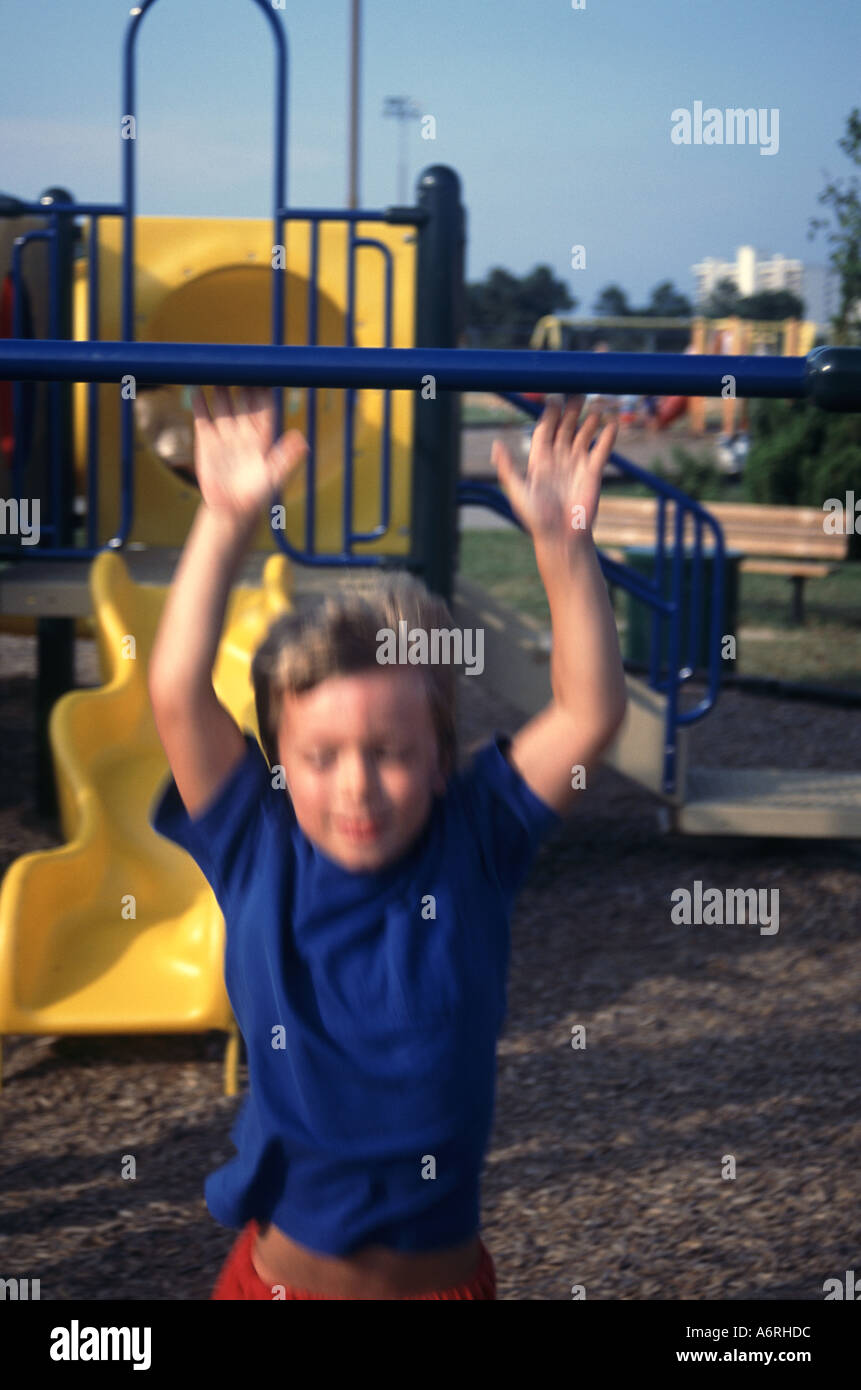 Young boy falling from a pull up bar at a playground Stock Photo - Alamy