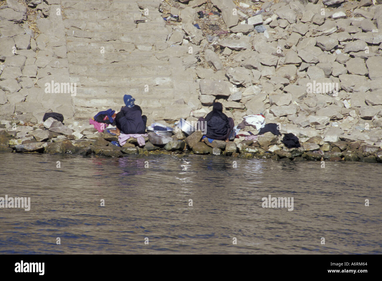 Africa, Egypt. Women doing morning laundry along the banks of the Nile ...