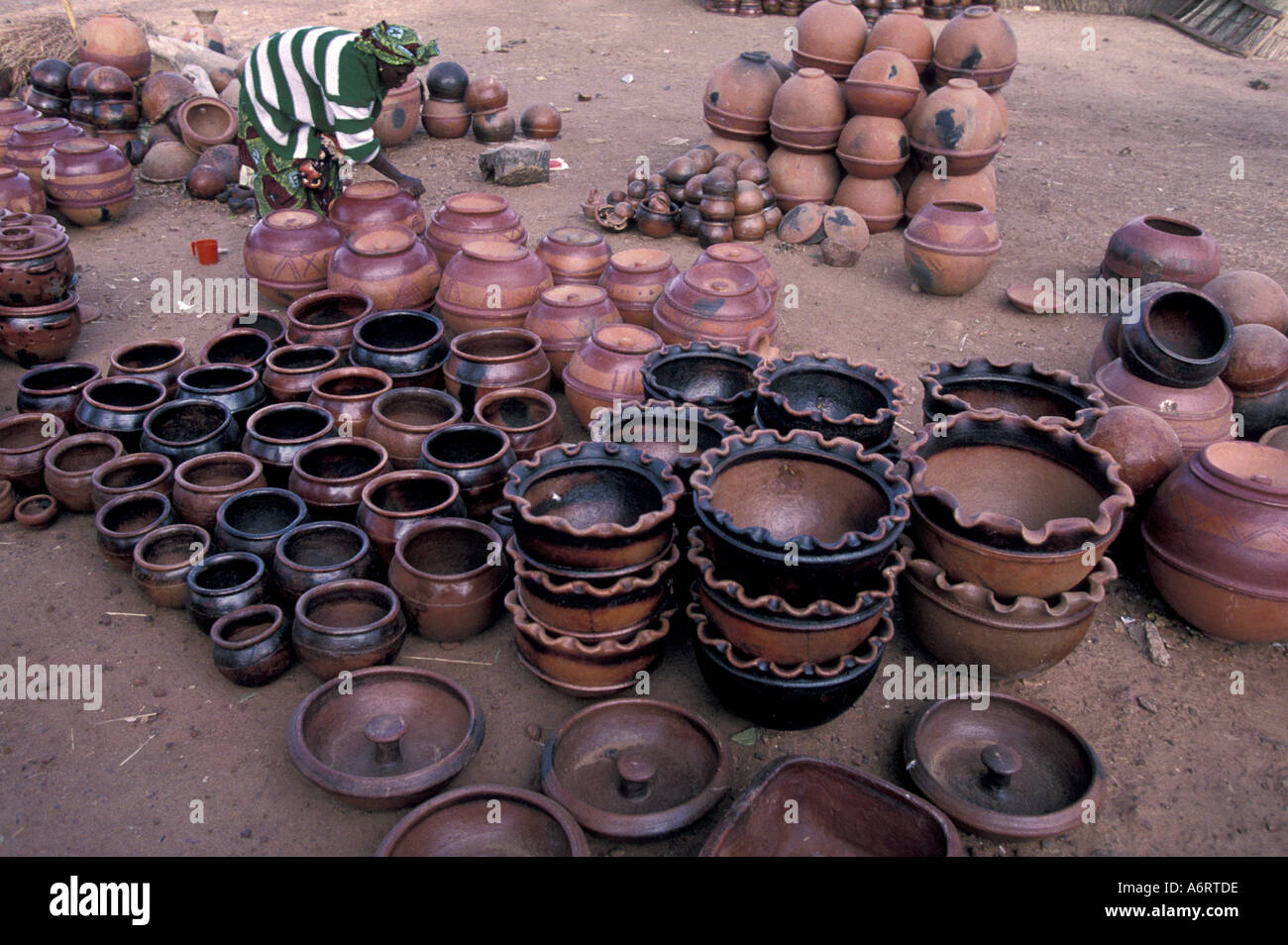 Africa, Mali, Dogon Region, Segou village. Woman with pottery for sale ...