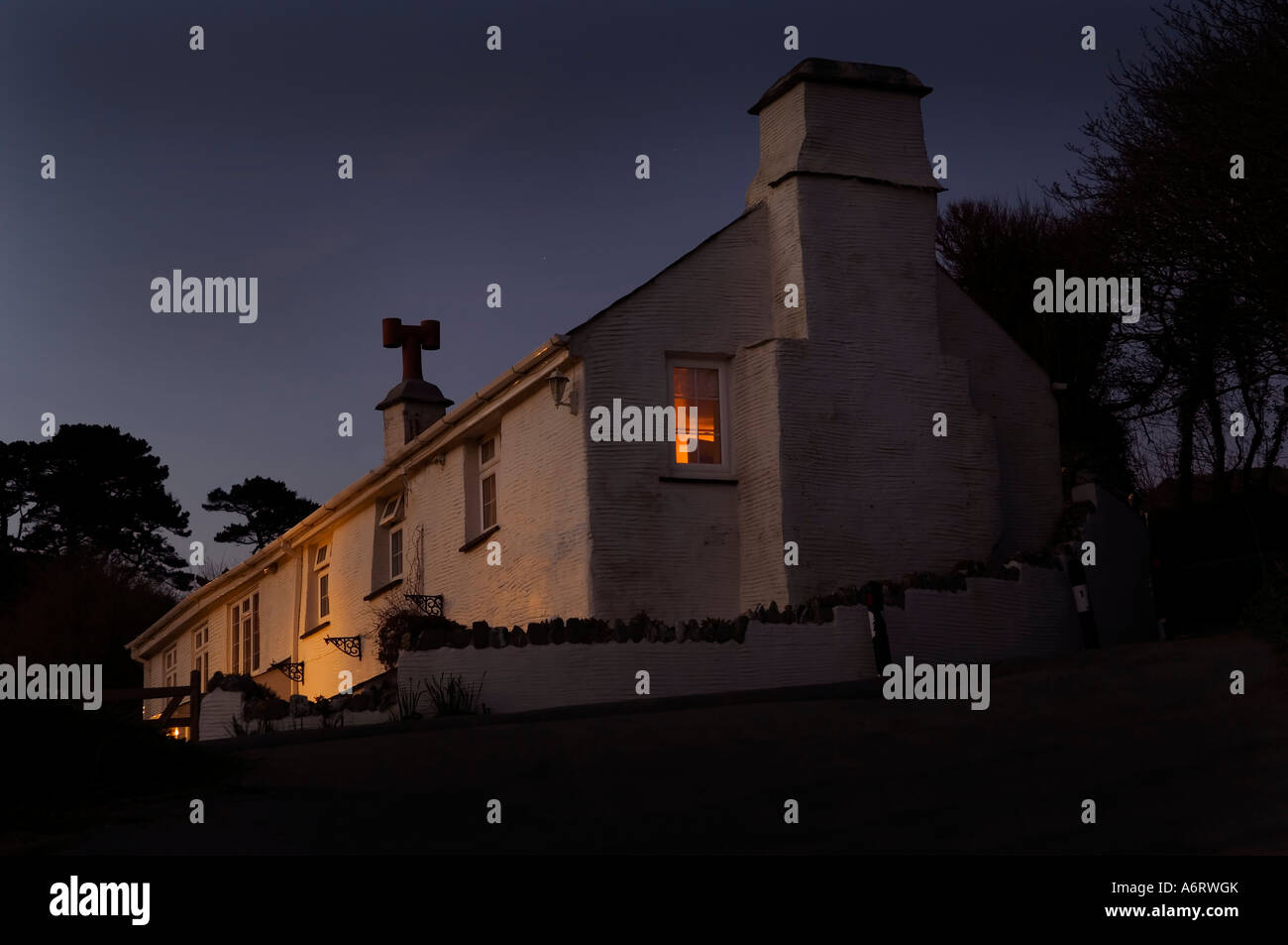 Cornish holiday Cottage at Dusk with welcoming window light Stock Photo ...
