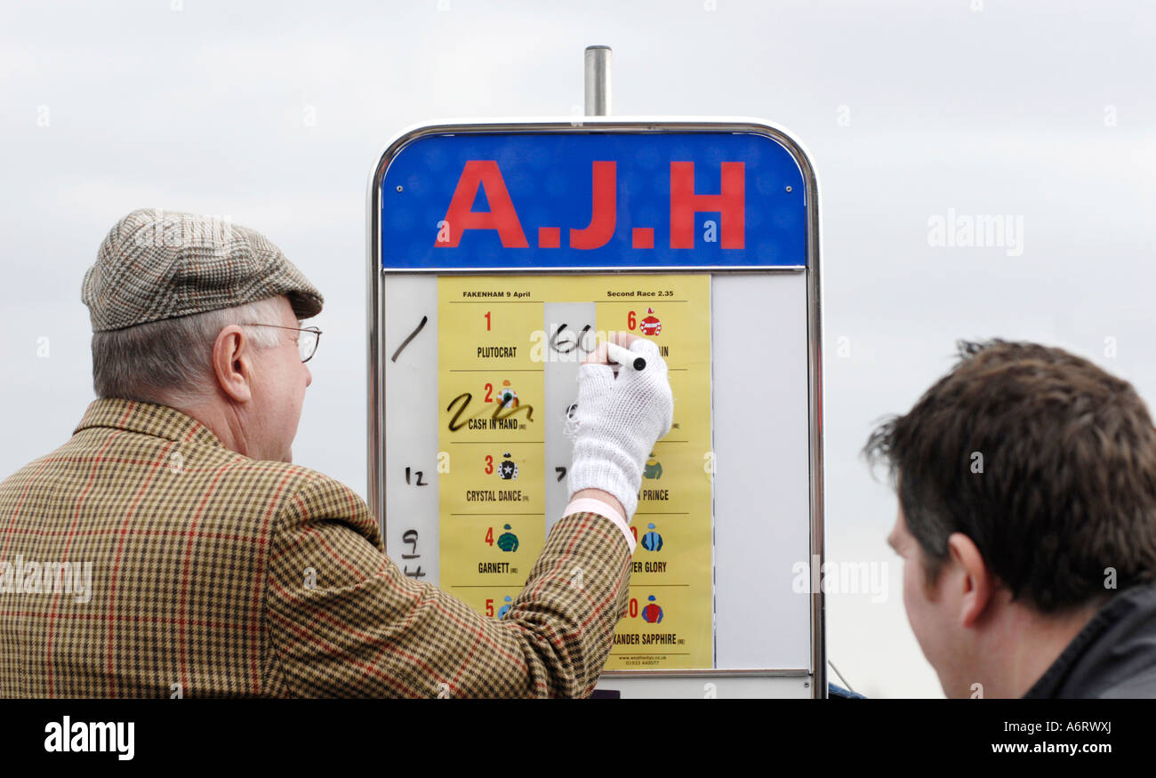 Racecourse bookmaker adjusting the odds Stock Photo - Alamy