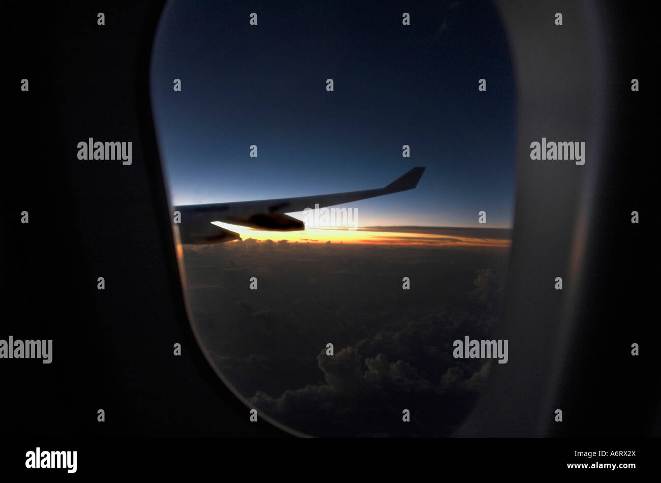 Sunset under wing through aircraft window Stock Photo - Alamy