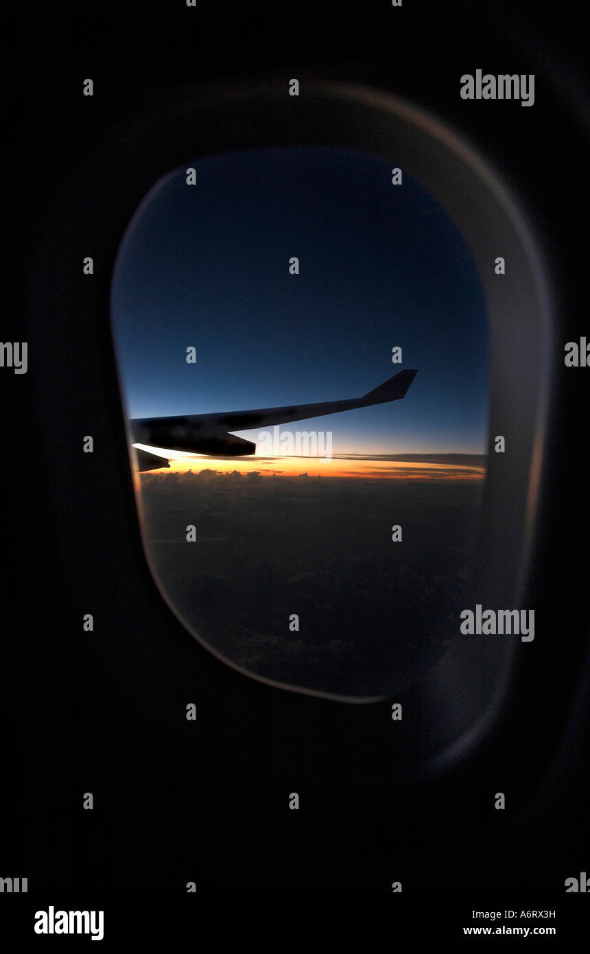 Sunset under aircraft wing through aircraft window Stock Photo - Alamy