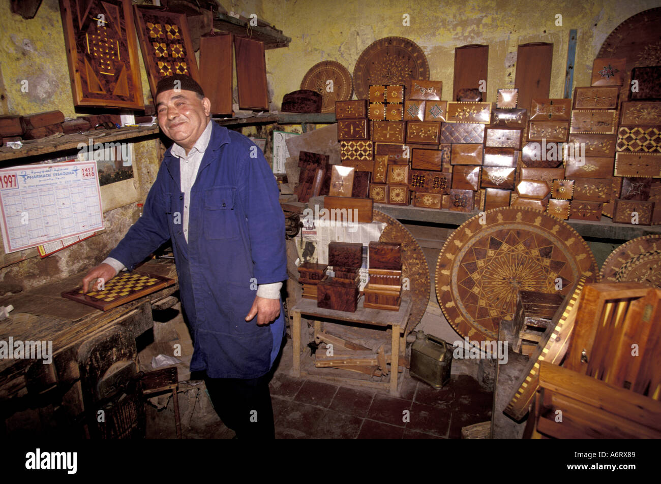 Africa, Morocco, Essaouira, Woodworker with thuya wood handicrafts ...