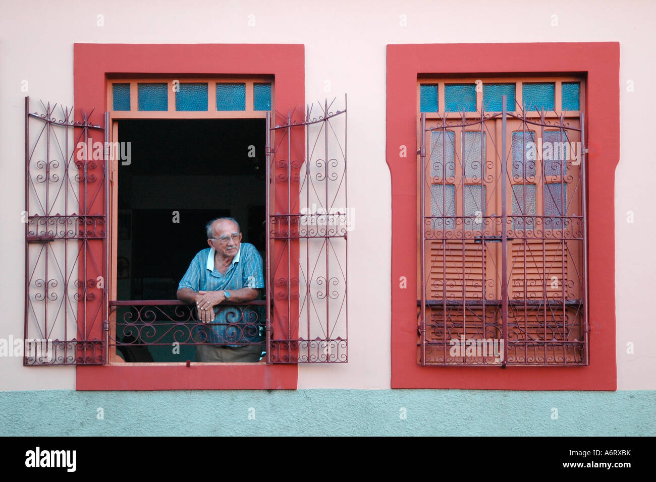 Man watching from a window in Olinda Pernambuco Brazil South America ...