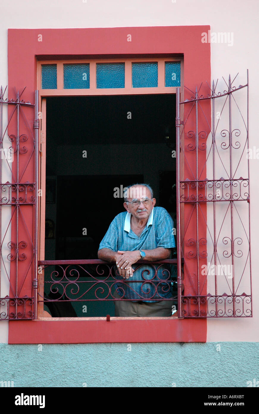 Man watching from a window in Olinda Pernambuco Brazil South America ...