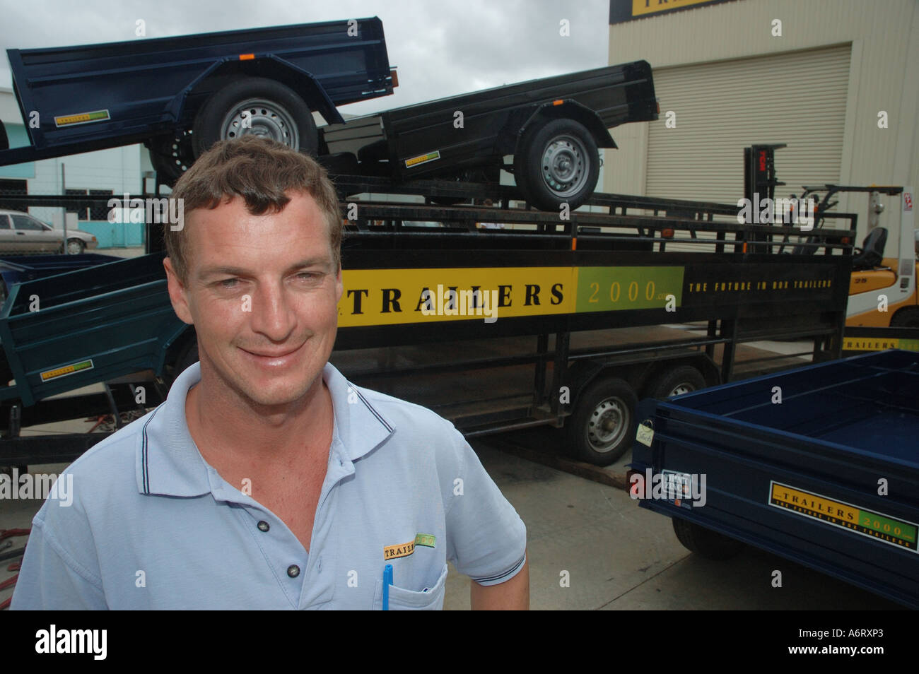 worker with box trailer ready for delivery Stock Photo - Alamy