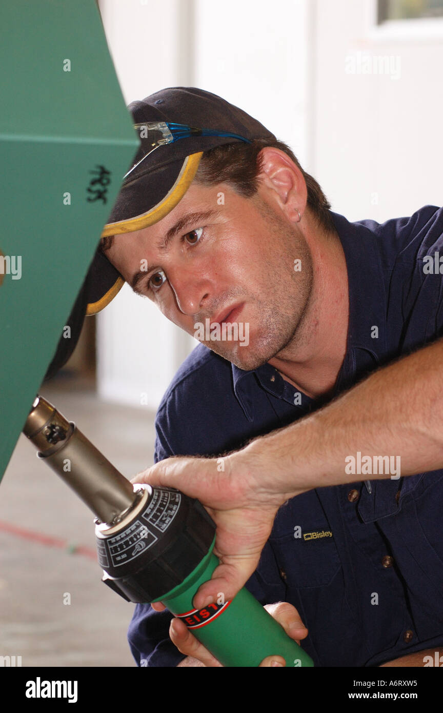 Factory worker manufacturing plastic rainwater tanks Noosa Queensland ...