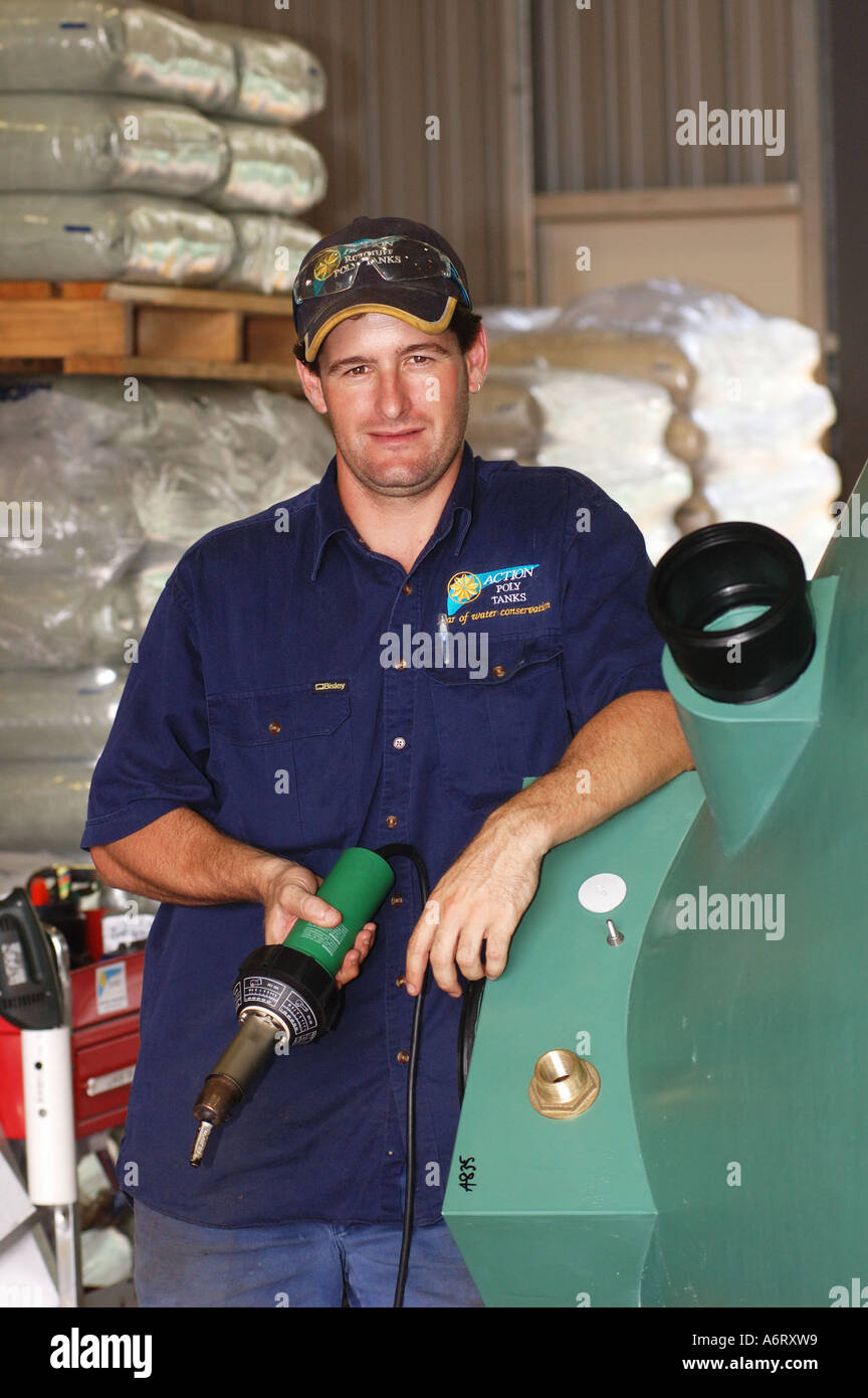 Factory worker manufacturing plastic rainwater tanks Noosa Queensland ...