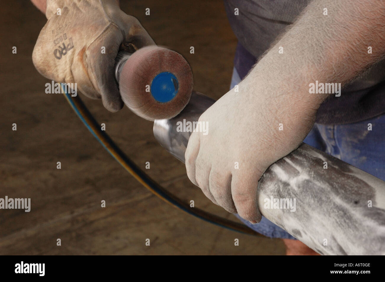 worker polishing a stainless steel pipe Stock Photo - Alamy
