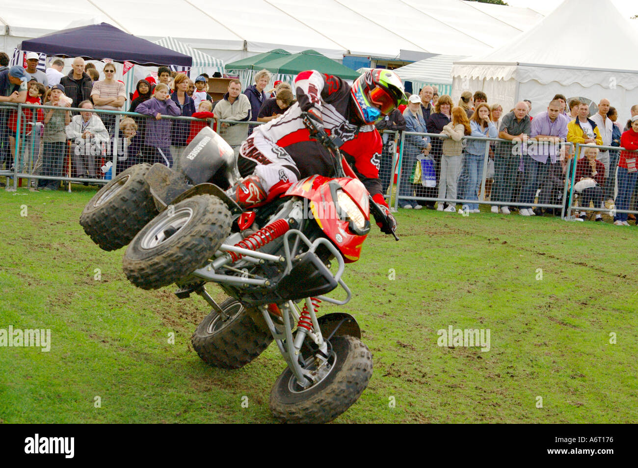Quad bike on two wheels motorcycle stunt display team Stock Photo - Alamy
