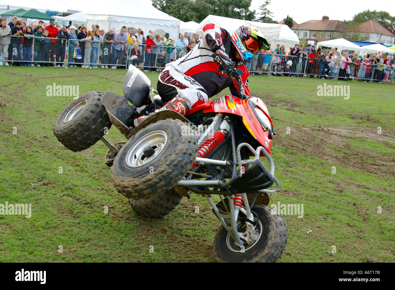Quad bike on two wheels motorcycle stunt display team Stock Photo - Alamy