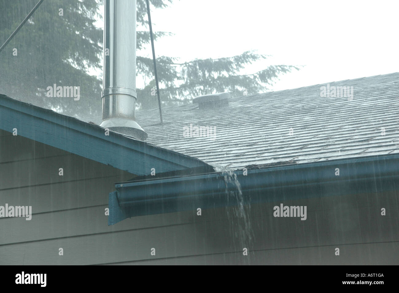 Torrents of rain pouring off a roof Stock Photo - Alamy