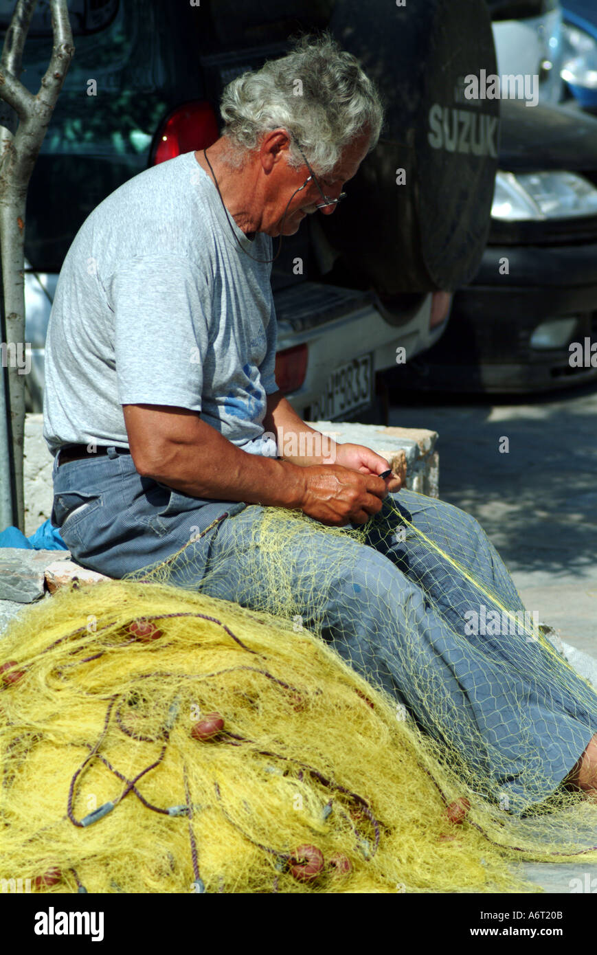 Fisherman mending nets Stock Photo - Alamy