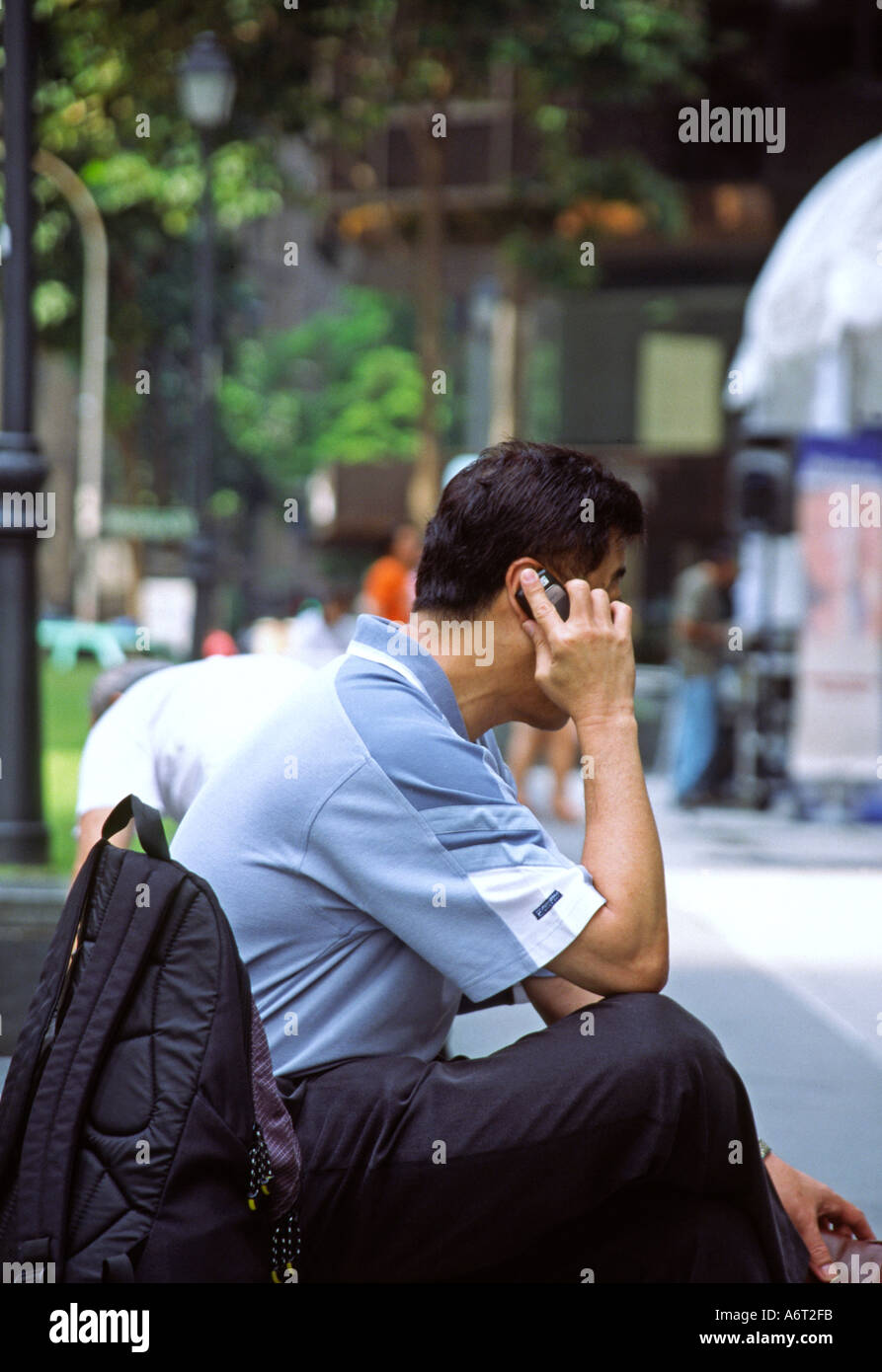 Chinese man talking on mobile phone Singapore Stock Photo - Alamy