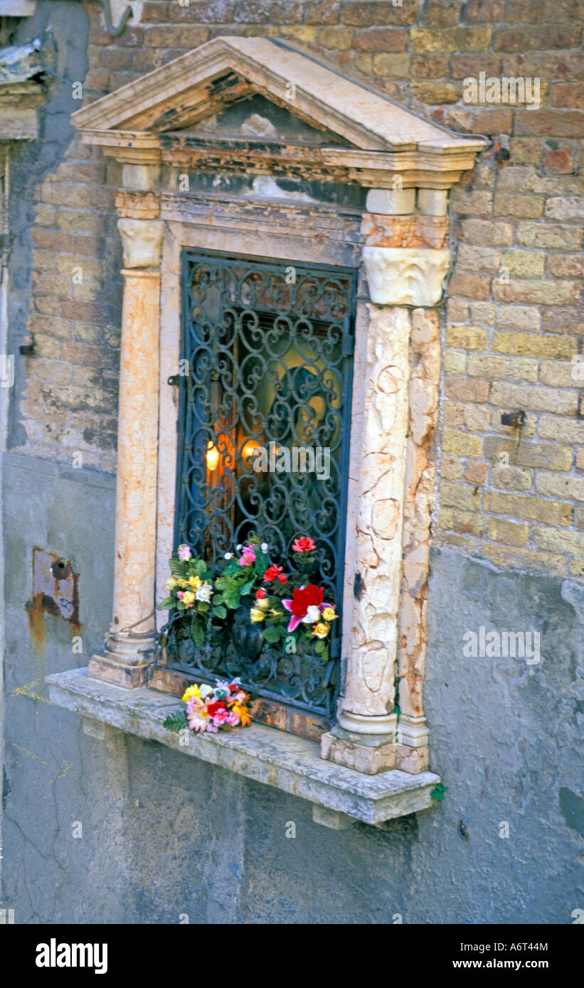 Holy shrine built into a wall in Venice, Italy Stock Photo - Alamy