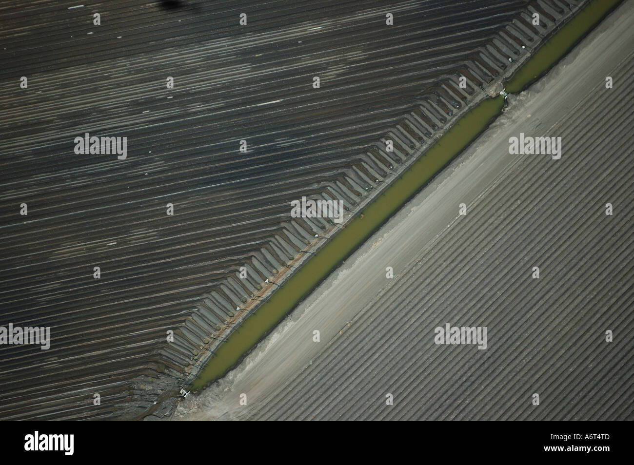 irrigation ditch in dry area wheat and cotton fields Stock Photo - Alamy